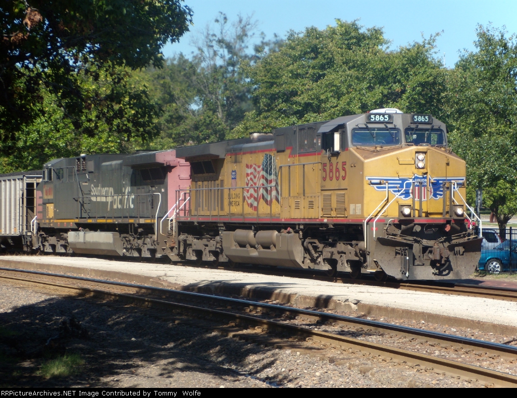 UP 5865 leads loaded coal eastbound with a patched SP trailing